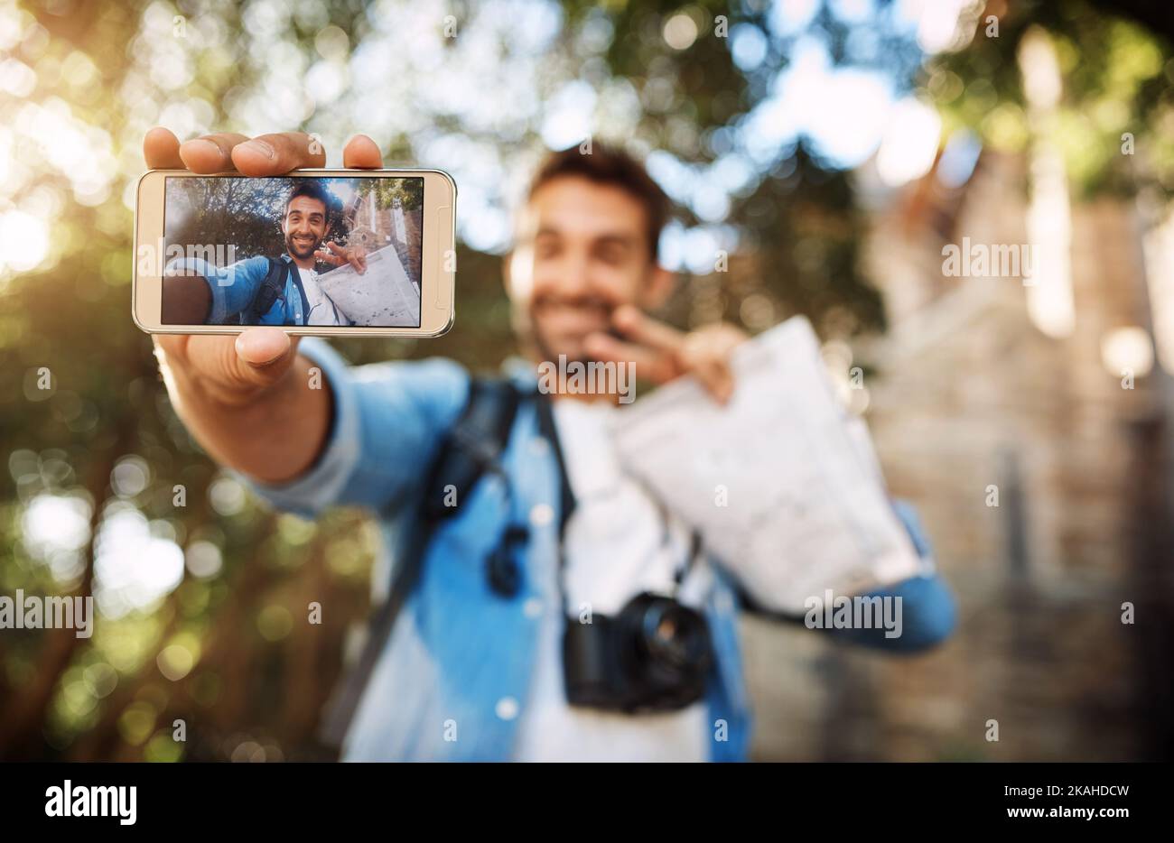 Photographs of his travel highlights. a handsome young man taking ...