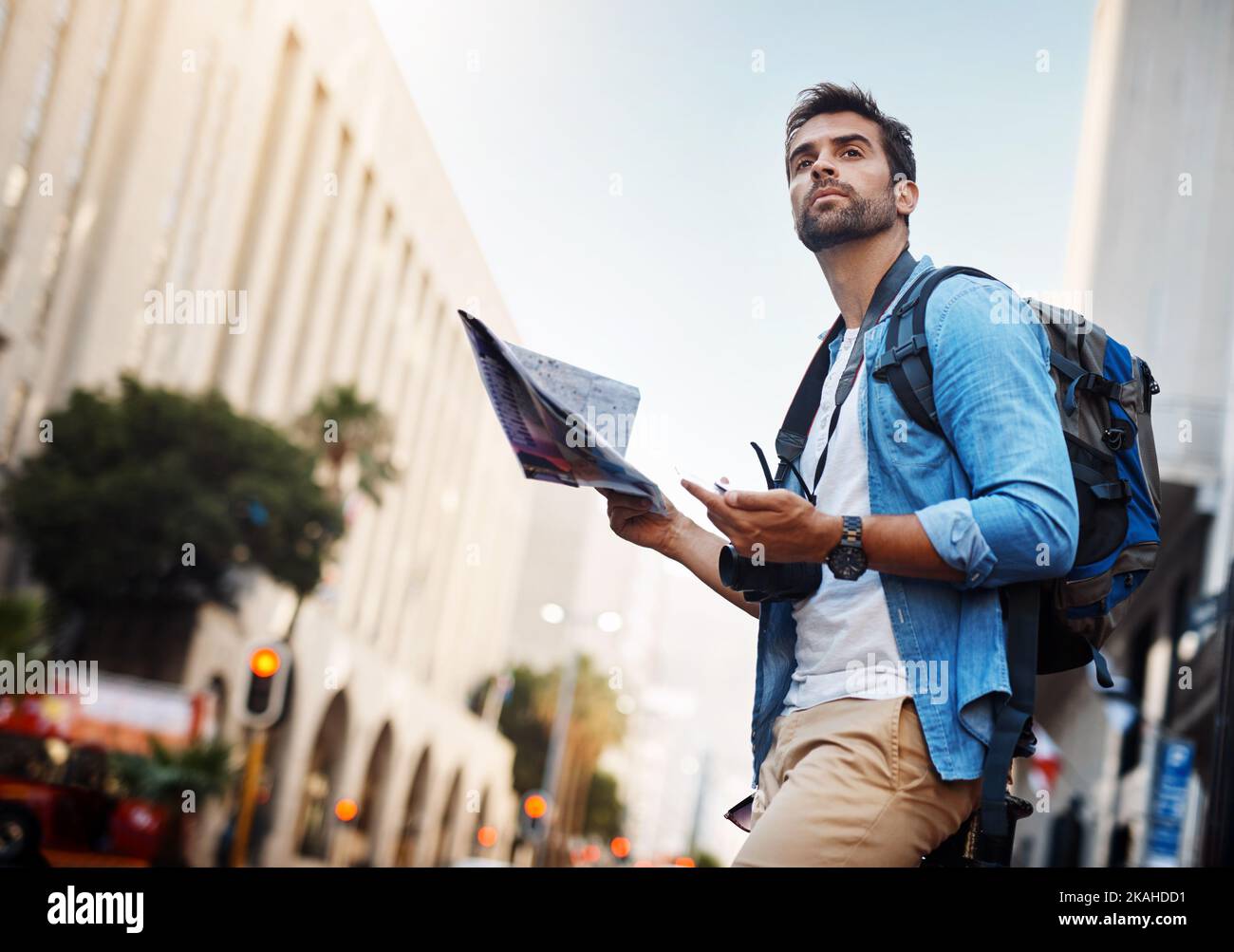 Left or right. a handsome young man looking at a map while touring a ...
