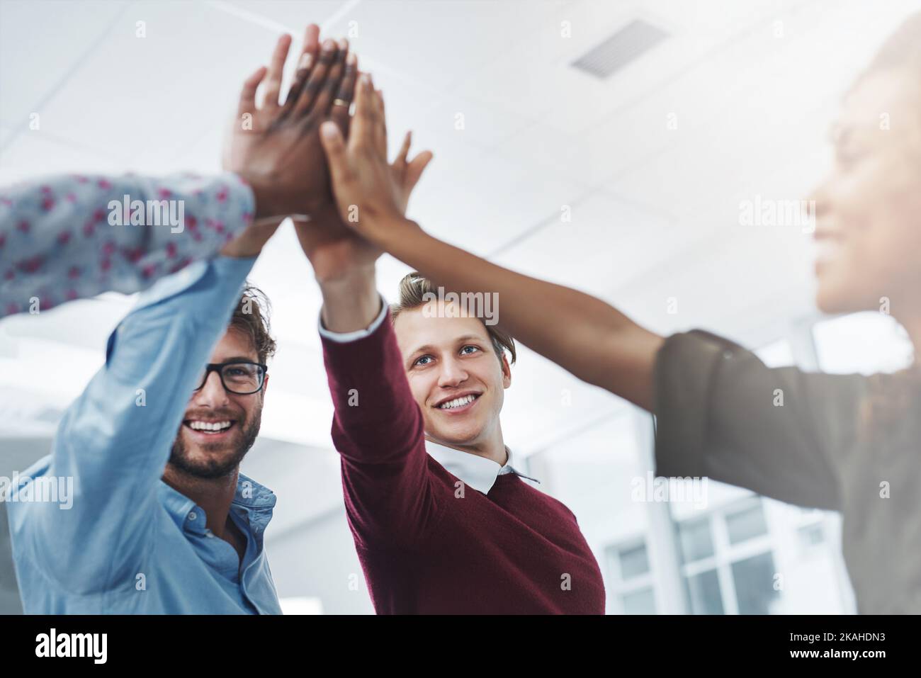 The take action team. a team of young go getters giving each other a ...