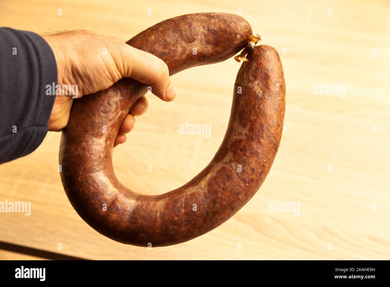 Homemade kangal sucuk made from various spice mixtures used in Turkish cuisine, on hand and oak ...