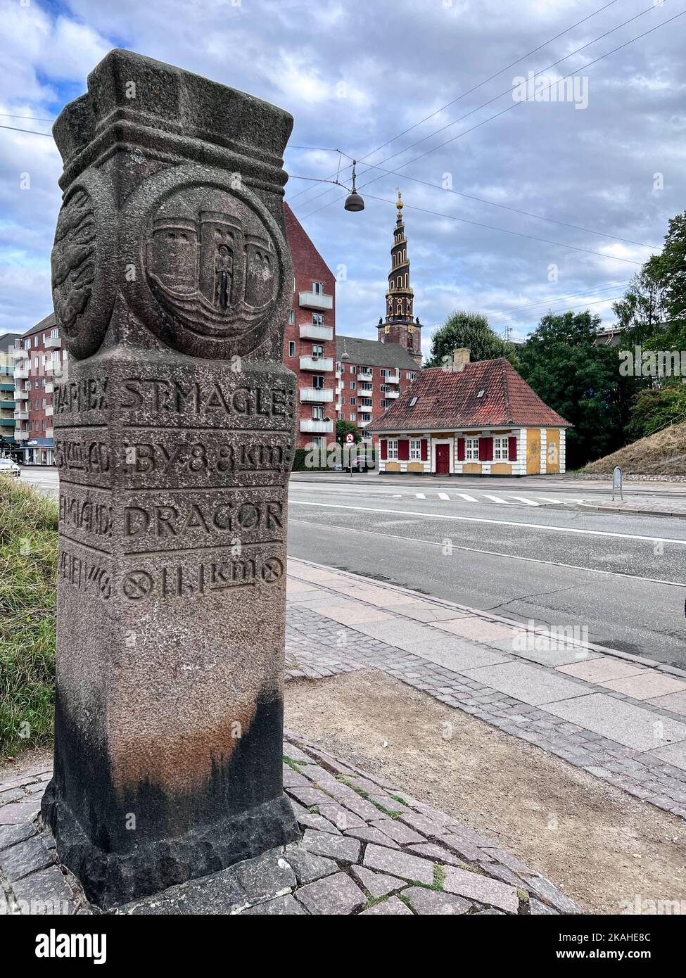 Historic stone milestone marker by the side of road with Our Saviour's ...