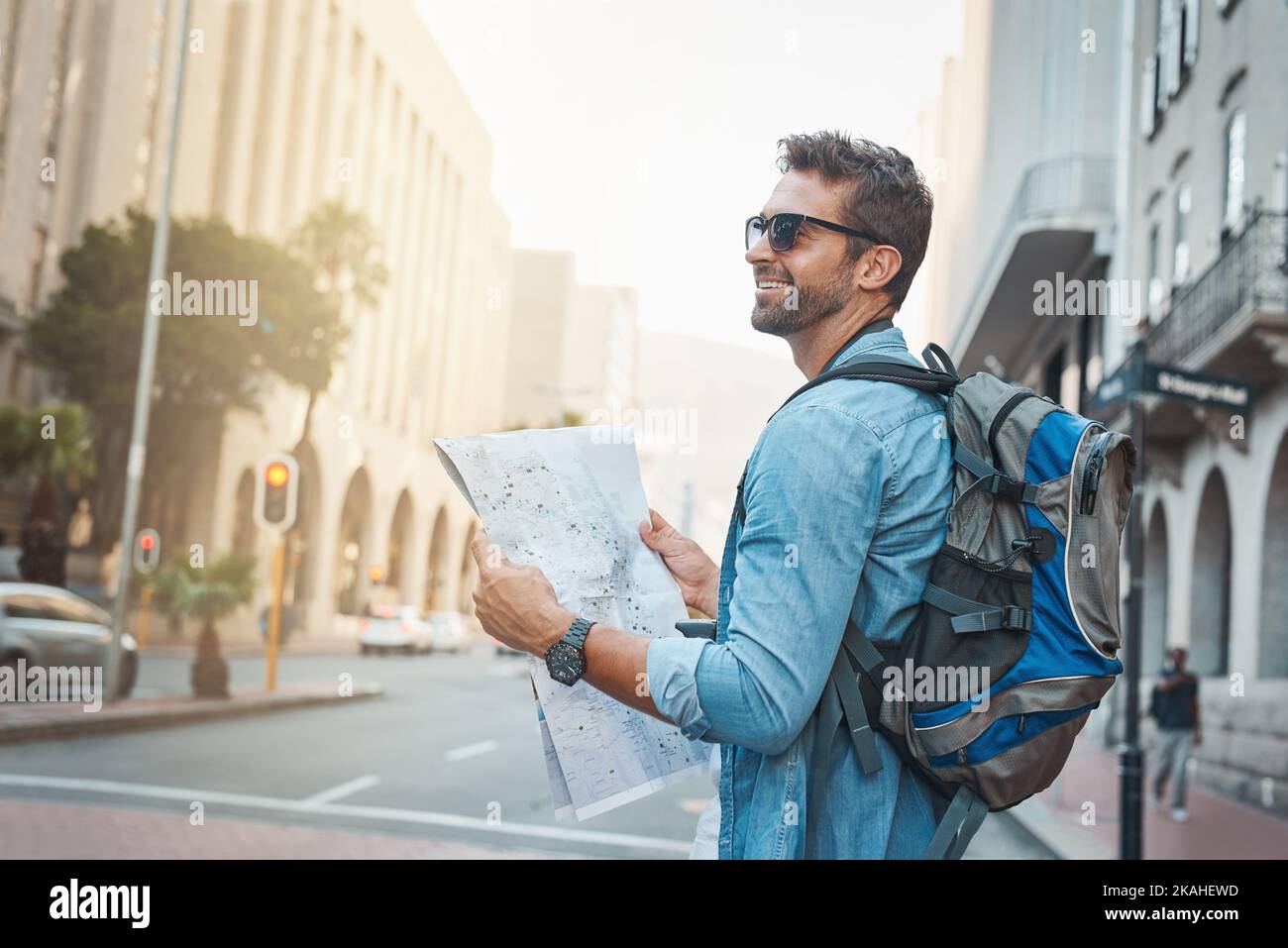 Theres so much to see. a young man looking at a map while touring a ...