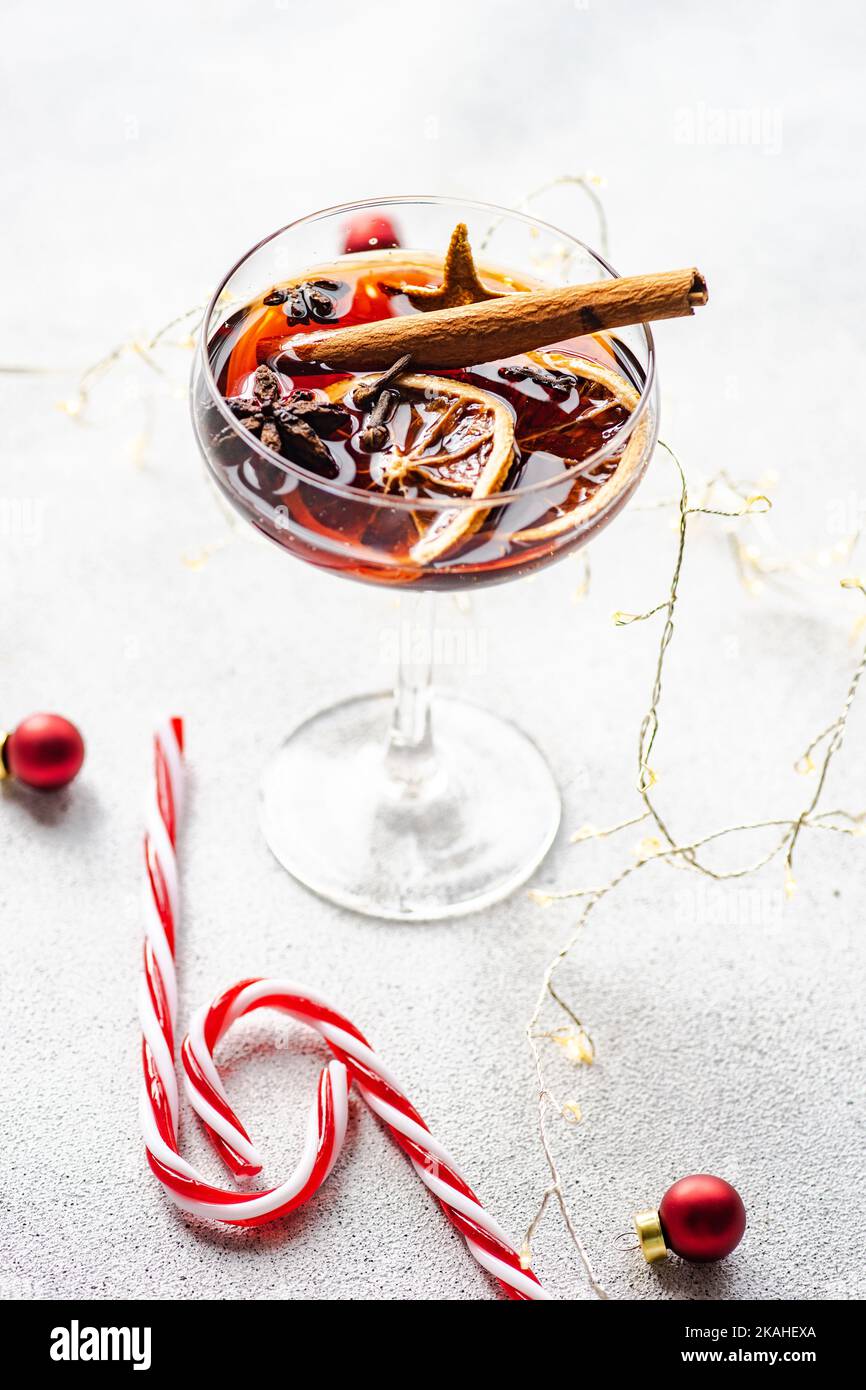 Glass of mulled wine with dried orange slices, cinnamon sticks and star ...