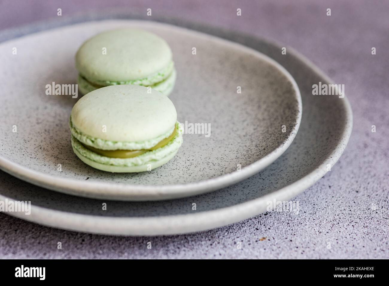 Close-up of two pistachio macaroons on a plate Stock Photo - Alamy