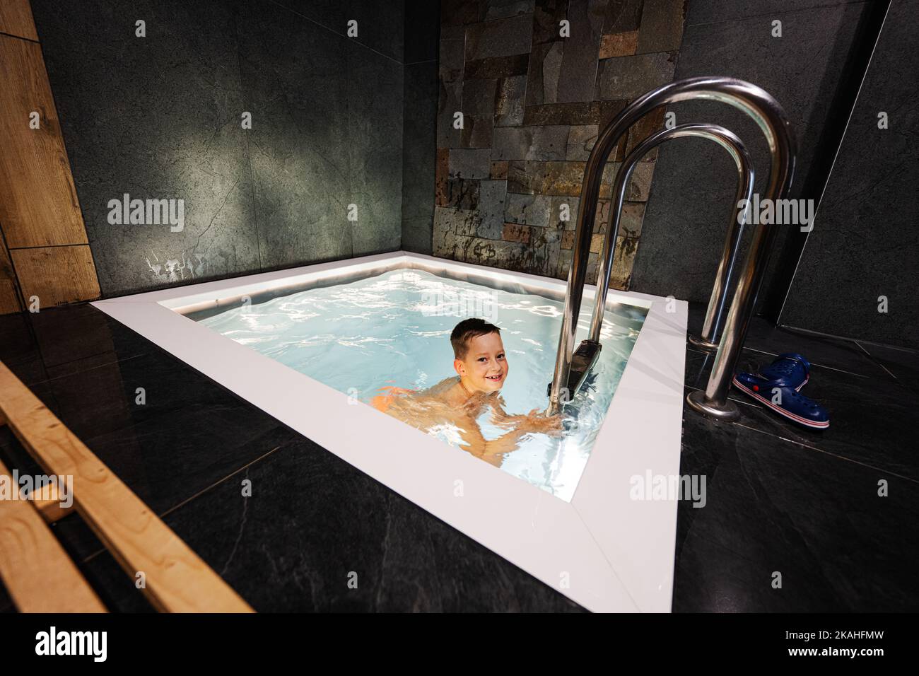 Boy swimming on spa pool at sauna Stock Photo - Alamy
