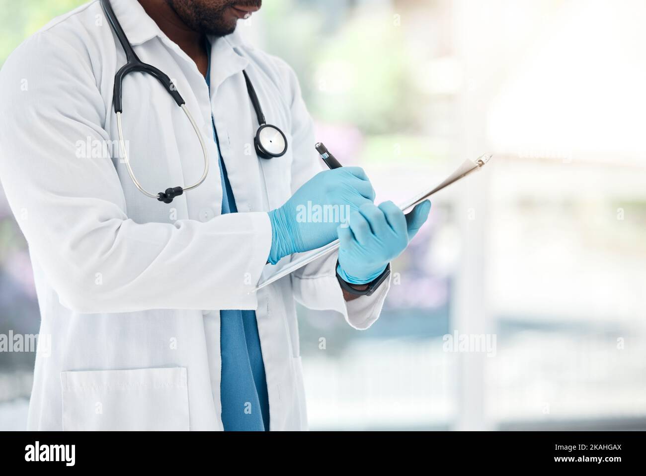 Healthcare, paper and doctor writing in a hospital, insurance and ...