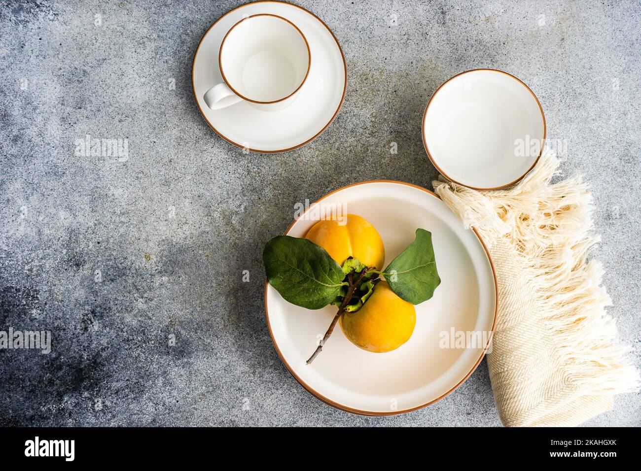 Overhead view of persimmon fruit and an empty coffee cup Stock Photo ...