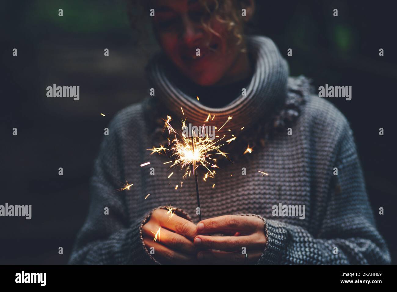 Woman celebration with sparkler light in the dark in outdoor leisure ...