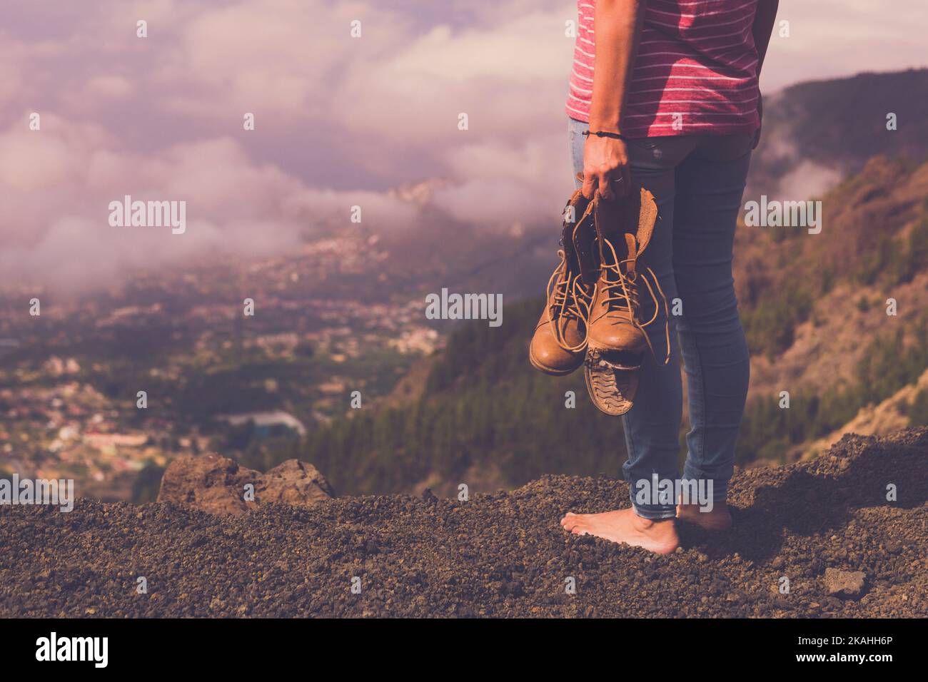 Concept back view of female people barefoot with broken shoes on hand ...