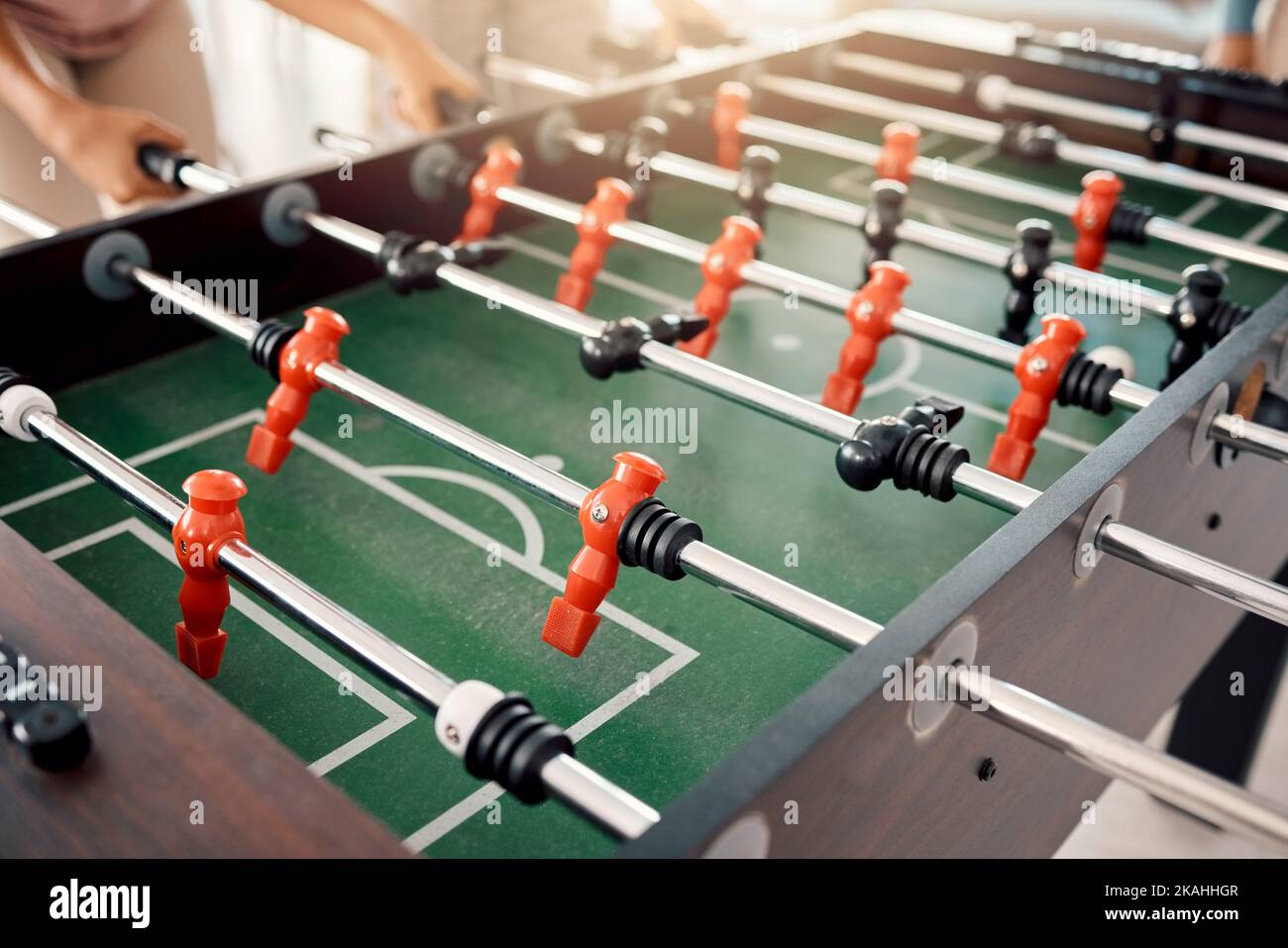 Foosball, game and fun with people playing a game inside of a clubhouse ...