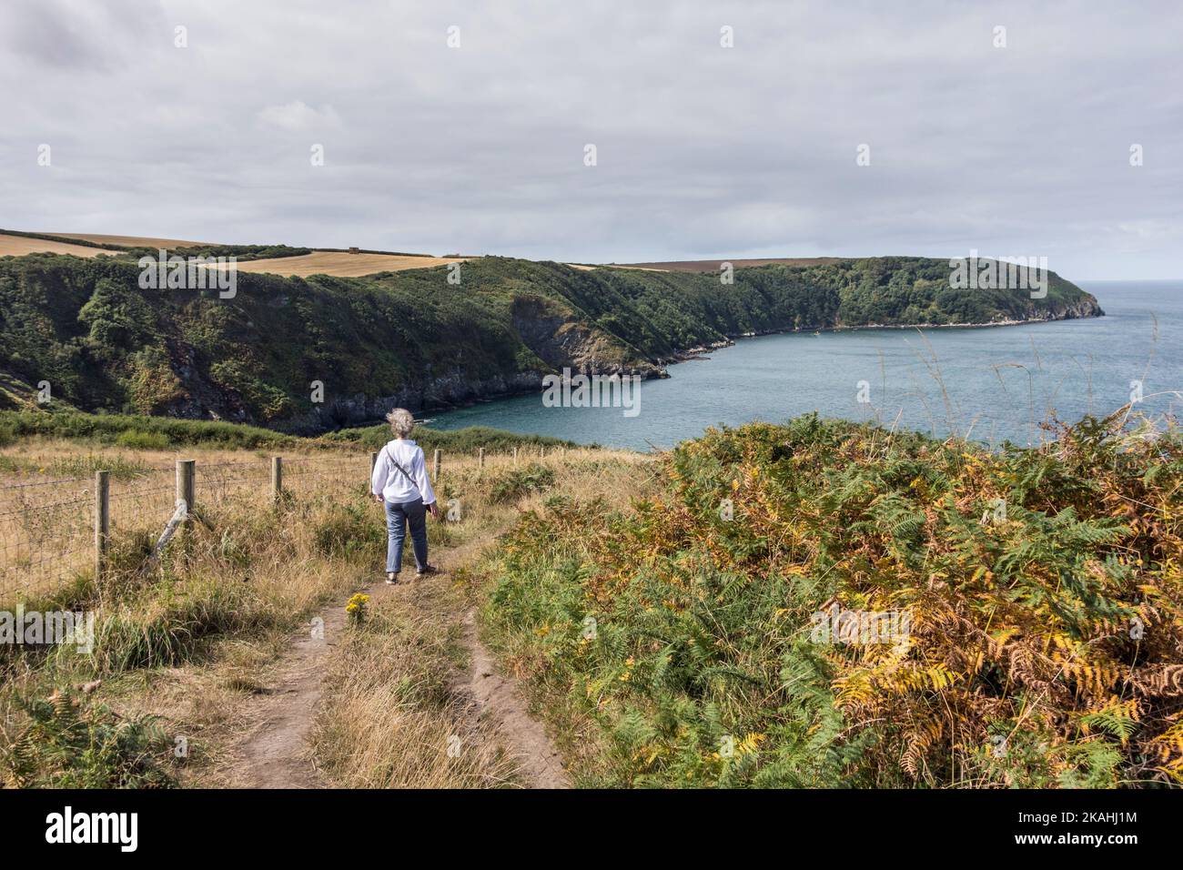 Woman walking along coastal footpath hi-res stock photography and ...