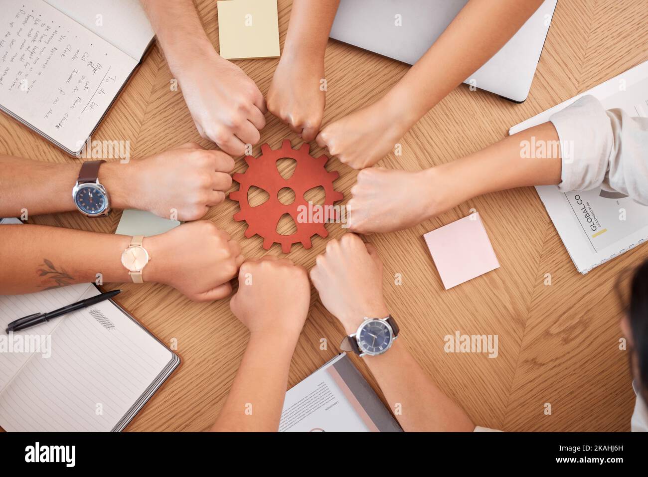 Hands, collaboration and gear with a business team working together at ...