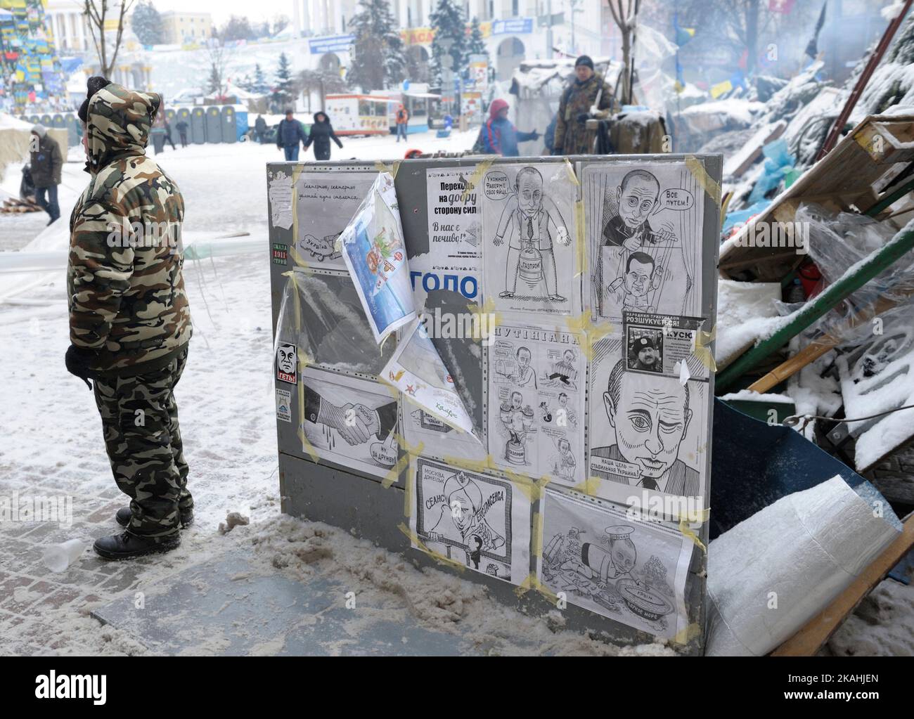 Caricatures on Vladimir Putin and Victor Yanukovich set on stand on the ...
