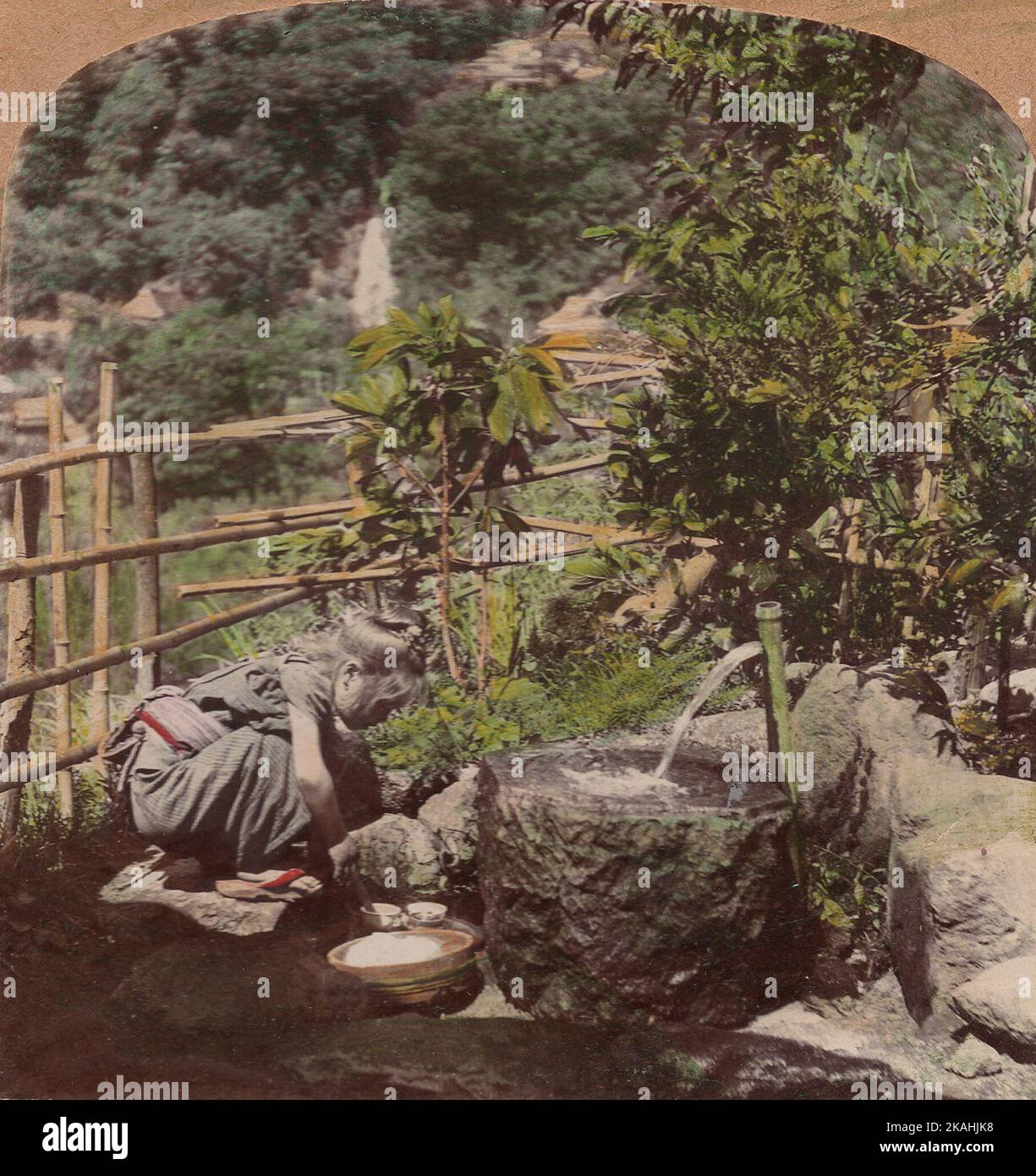 Japan, girl washing dishes outside Stock Photo - Alamy