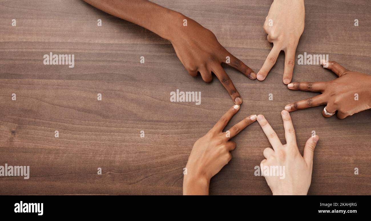 Hands, diversity and star shape on table for team building, community ...