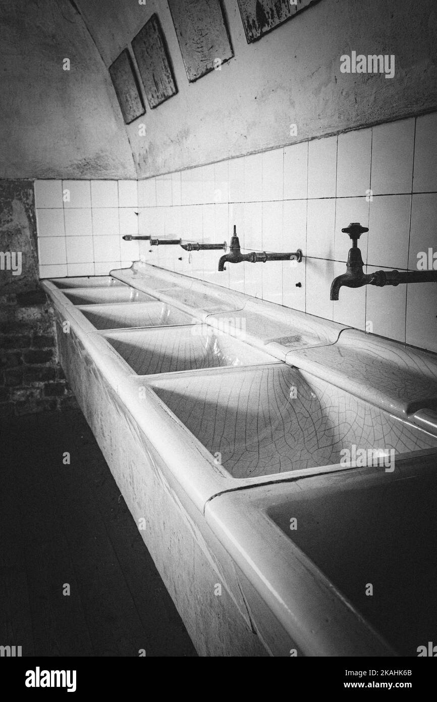 White ceramic inmate sinks in the wash house at the Terezin ...