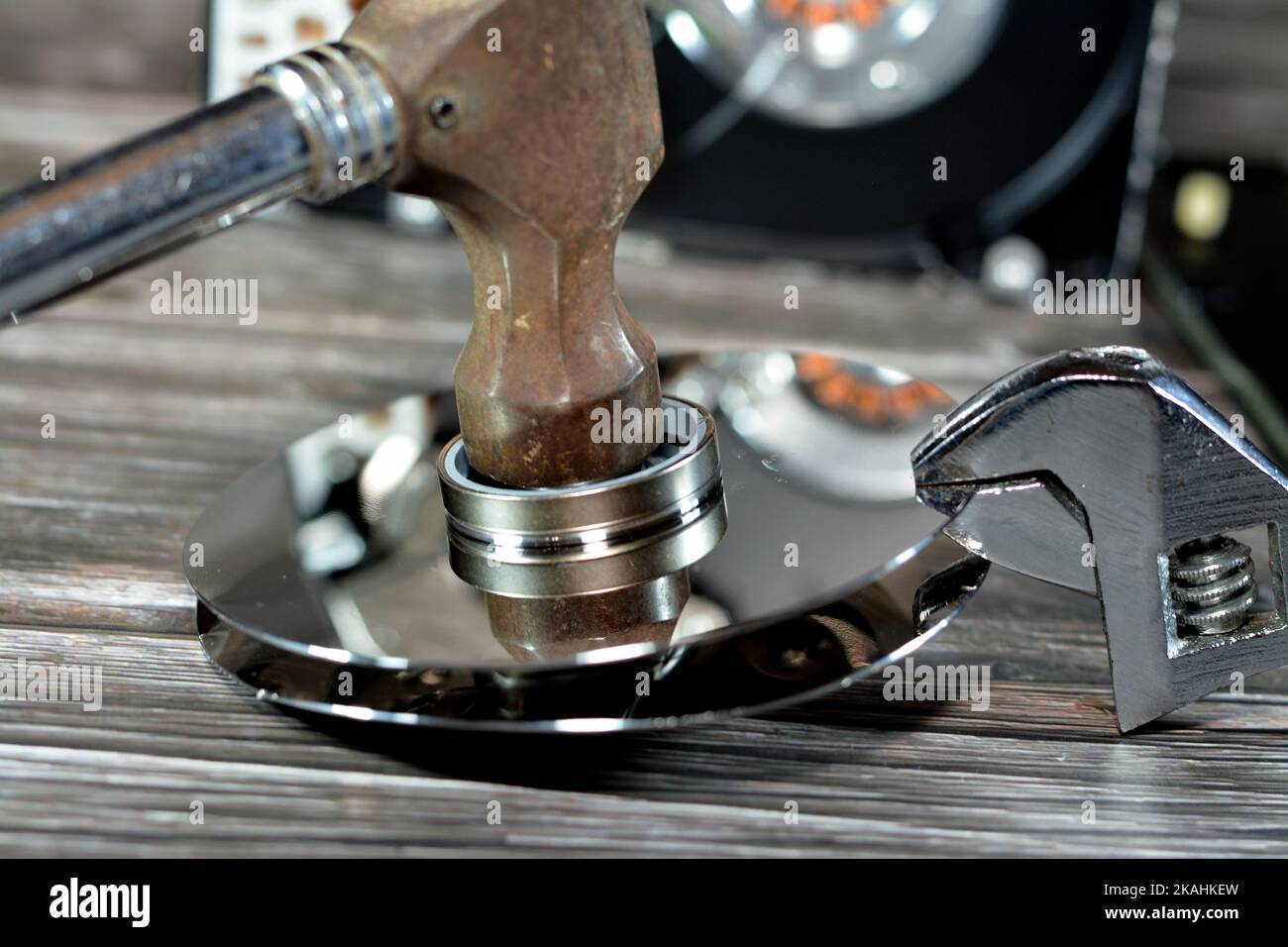 Spanner wrench and steel hammer with HDD platters, hard disk drive ... Spanner wrench and steel hammer with HDD platters, hard disk drive ...