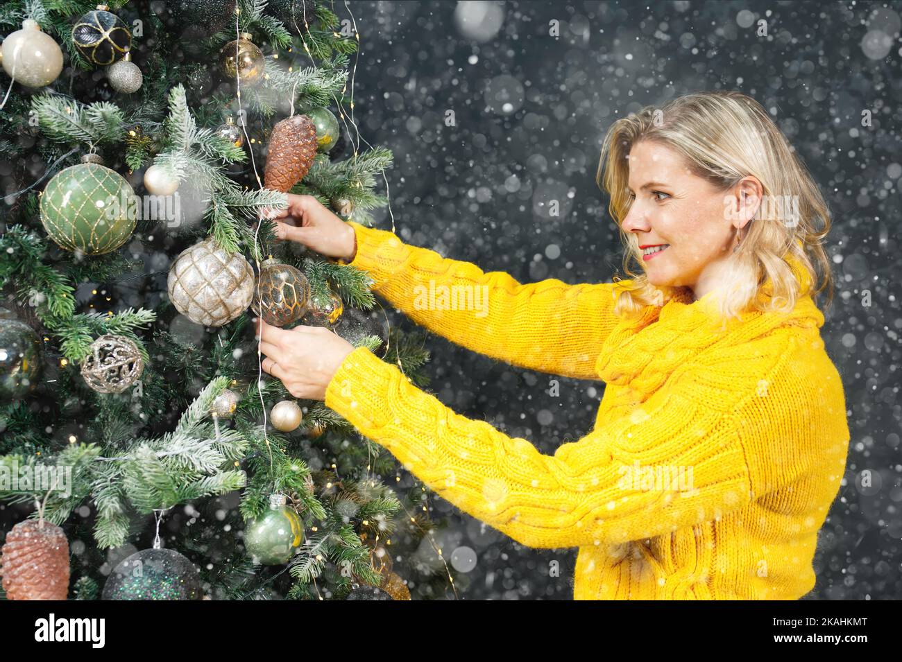 Woman decorating beautiful Christmas tree at home, closeup. christmas ...