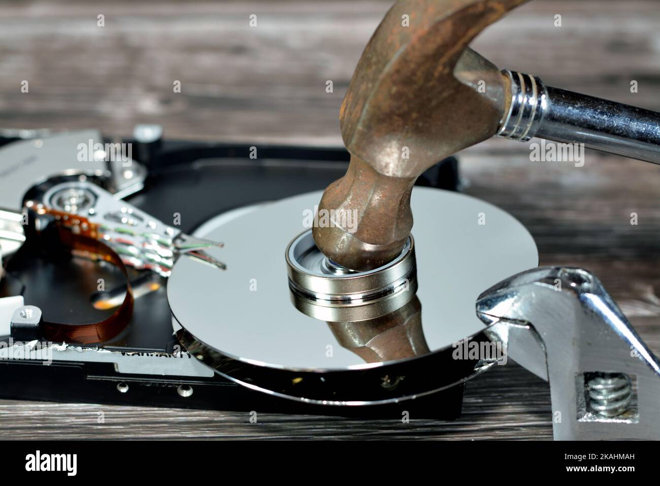 Spanner wrench and steel hammer with HDD platters, hard disk drive ... Spanner wrench and steel hammer with HDD platters, hard disk drive ...