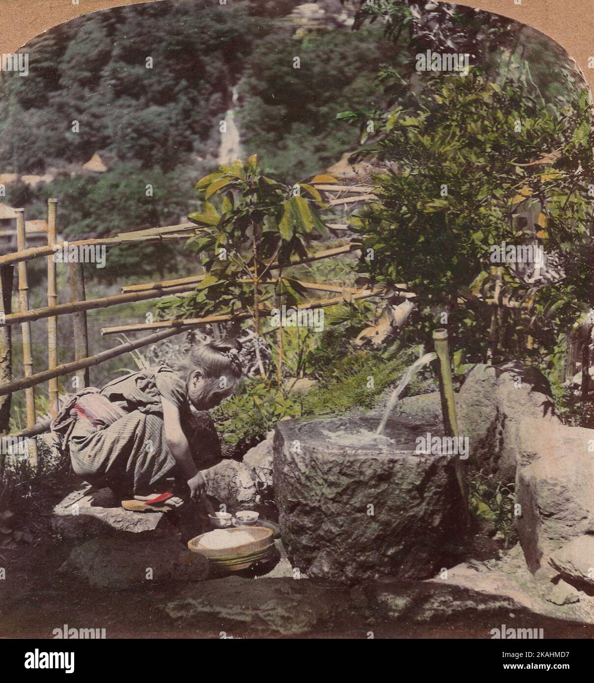 Japan, girl washing dishes outside Stock Photo - Alamy