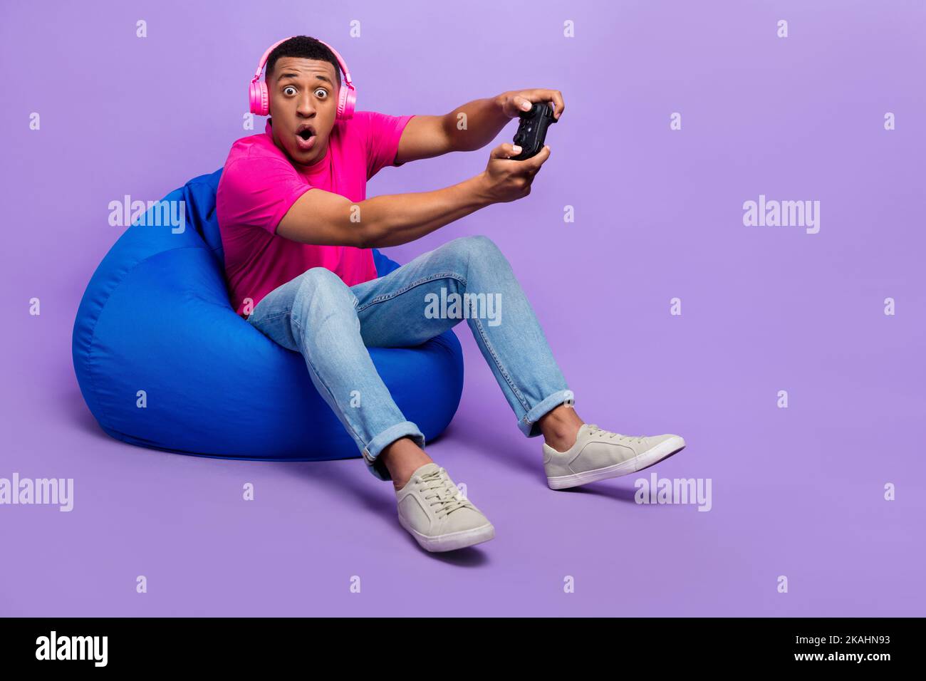 Full size photo of impressed gamer person sit comfy bag hold controller ...