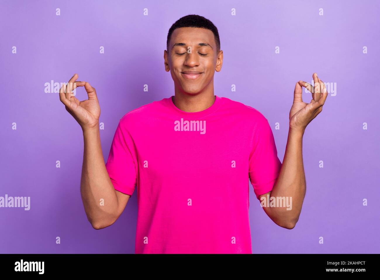 Photo of relaxed good mood positive guy box haircut dressed pink t ...