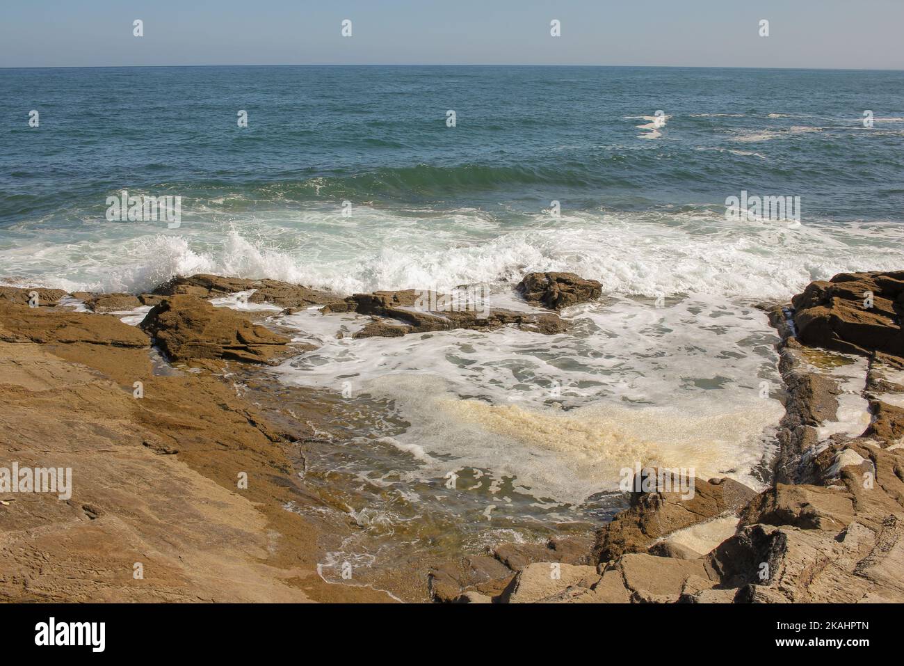 foam from waves seen from the rocks in the coast Stock Photo - Alamy