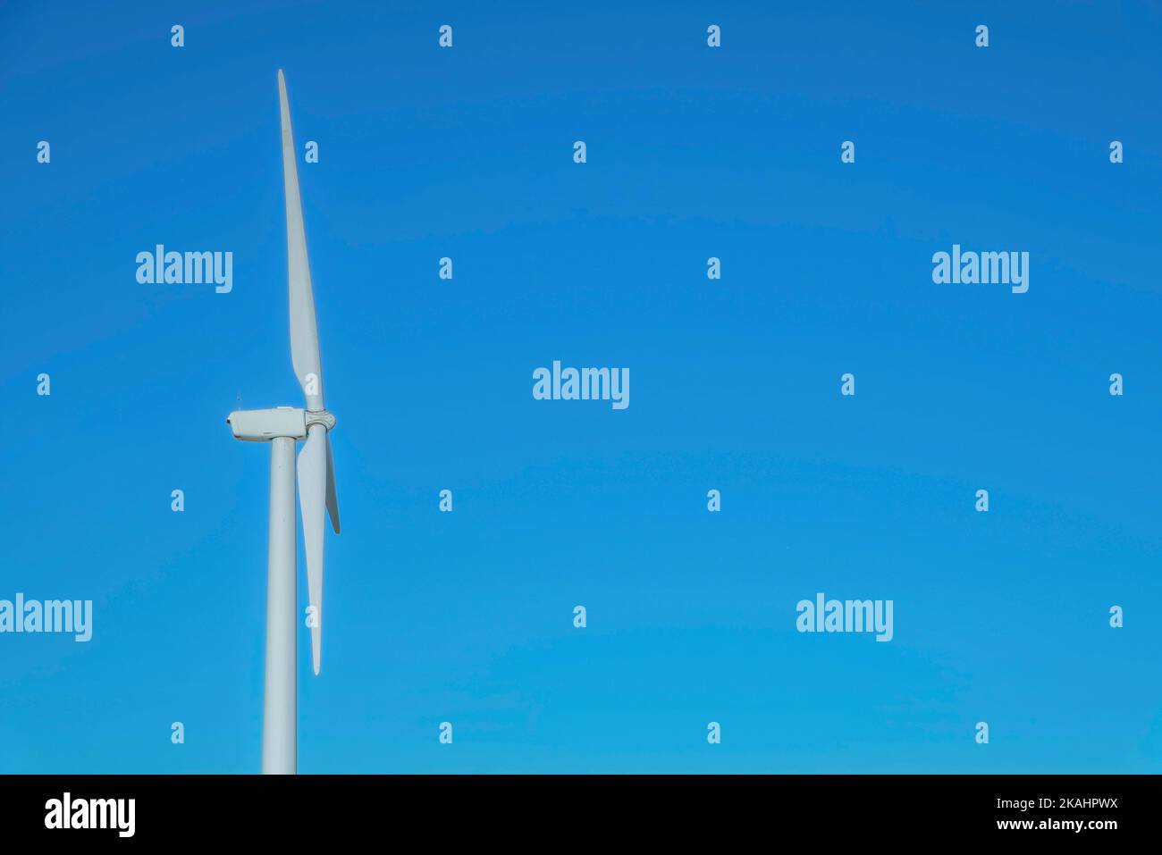 Close up side view of windmills with blue sky background on a sunny day ...