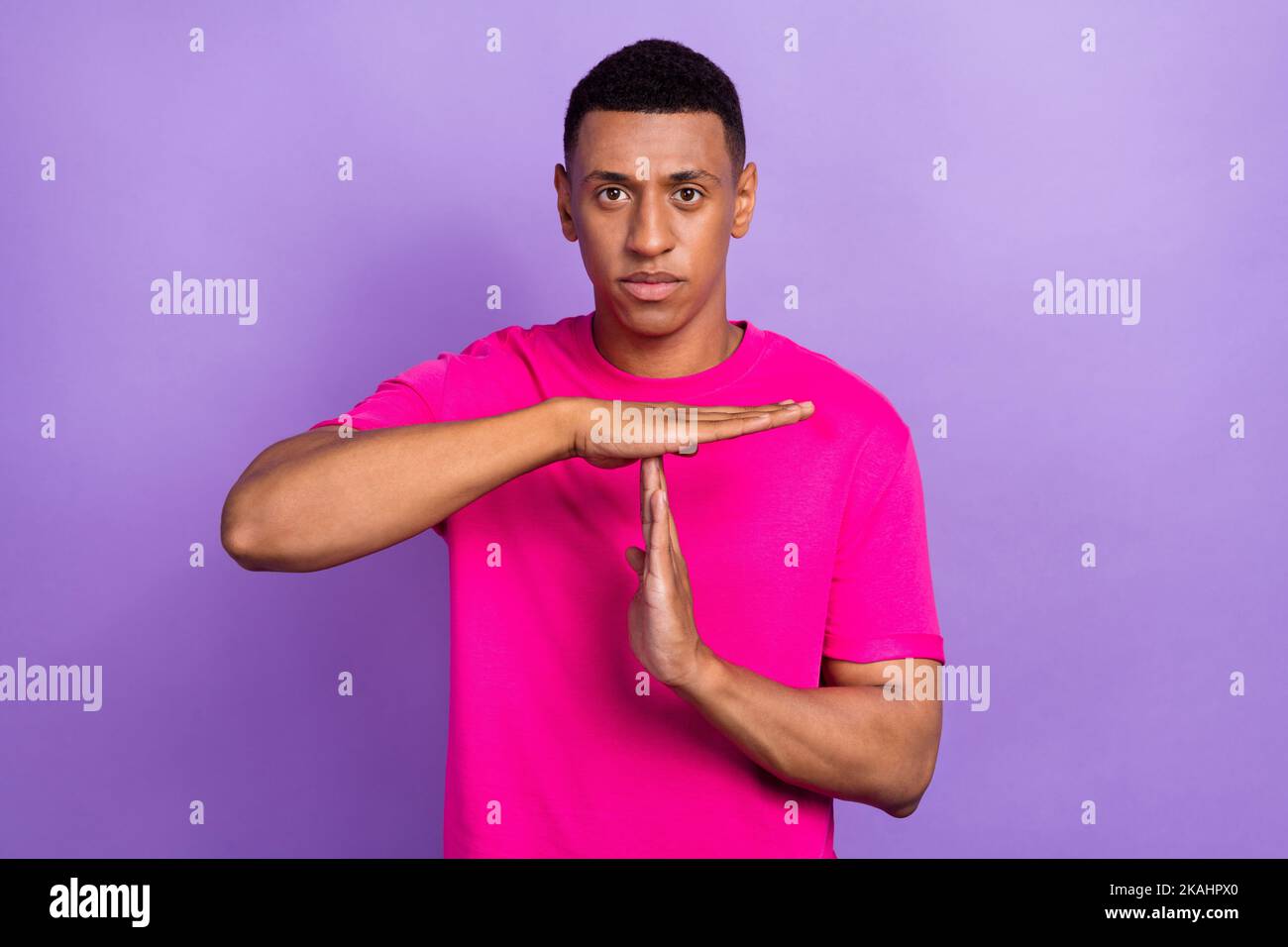 Photo of serious professional man showing hands time out symbol referee ...