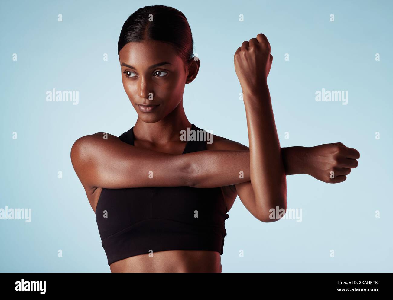 Fitness, studio and woman stretching shoulder and arms in a warm up to ...