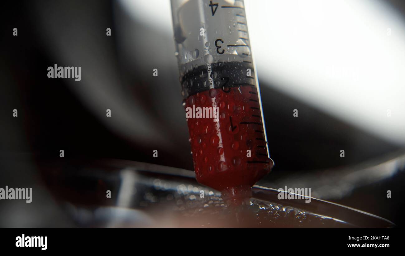 Syringe from which blood is drawn, taking medical blood sample ...