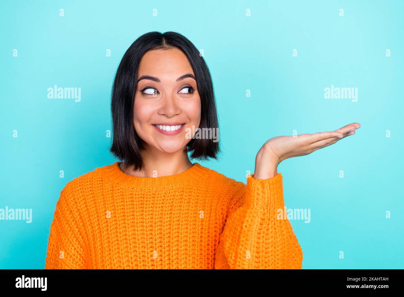 Portrait of funny woman bob hairstyle wear orange sweater demonstrating ...