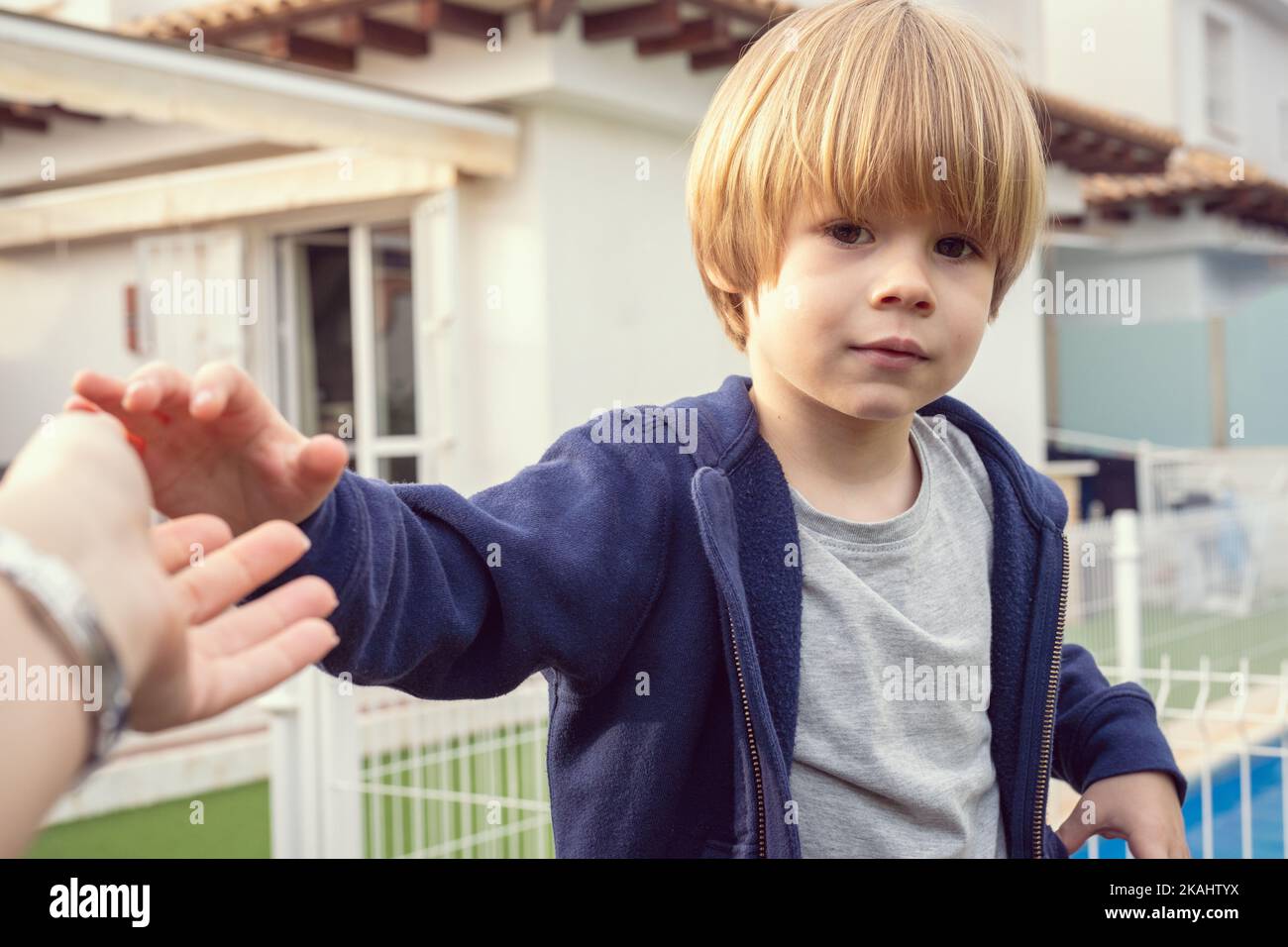 Close up of cute child blond boy giving hug to mum outdoors Stock Photo ...