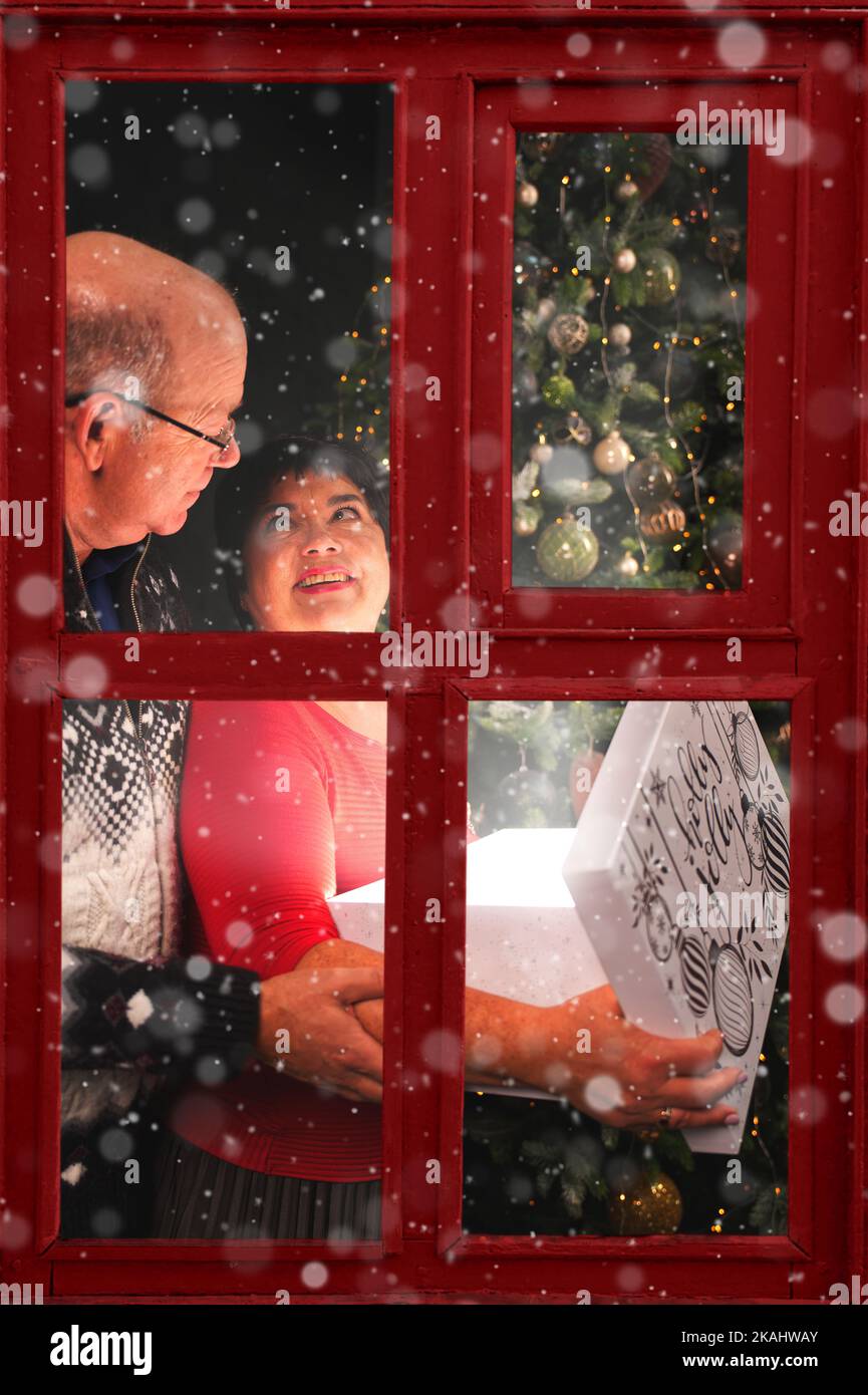 Christmas through the window. Christmas wonder. Man 60s giving a ...