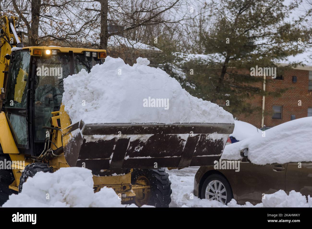 Clean up of snow with tractor after huge snowstorm in winter time after ...