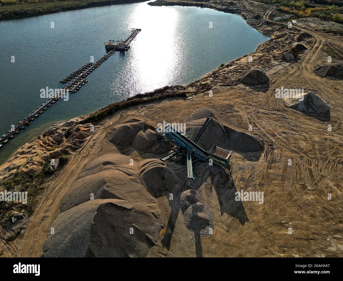 Aerial View of Mineral Mine and Extraction Equipment by a Calm Lake ...