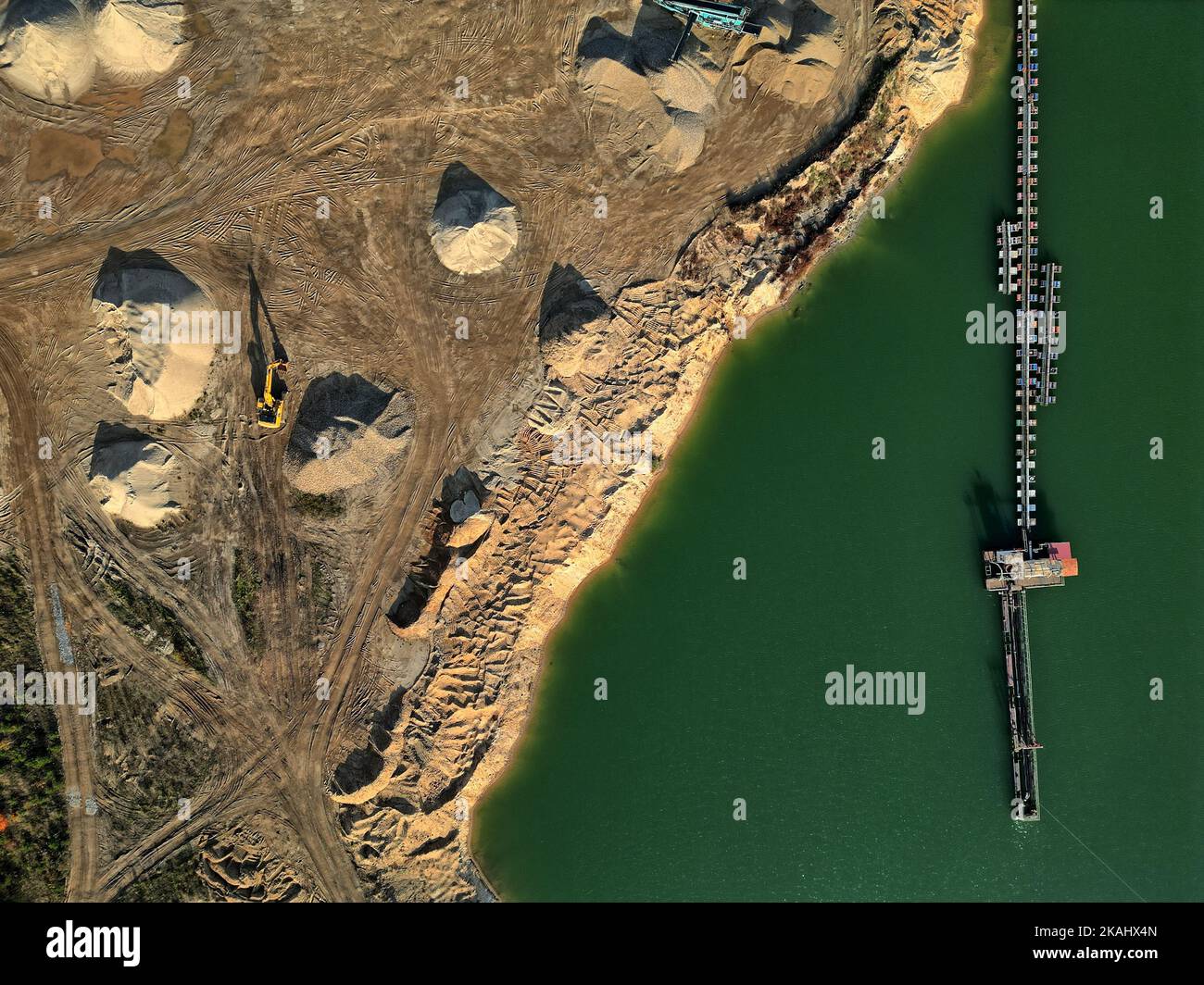 Aerial View of Mineral Mine and Extraction Equipment by a Calm Lake ...