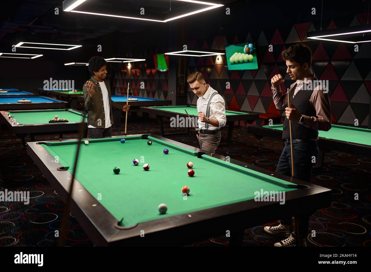 Company of handsome young guy playing in pool Stock Photo - Alamy