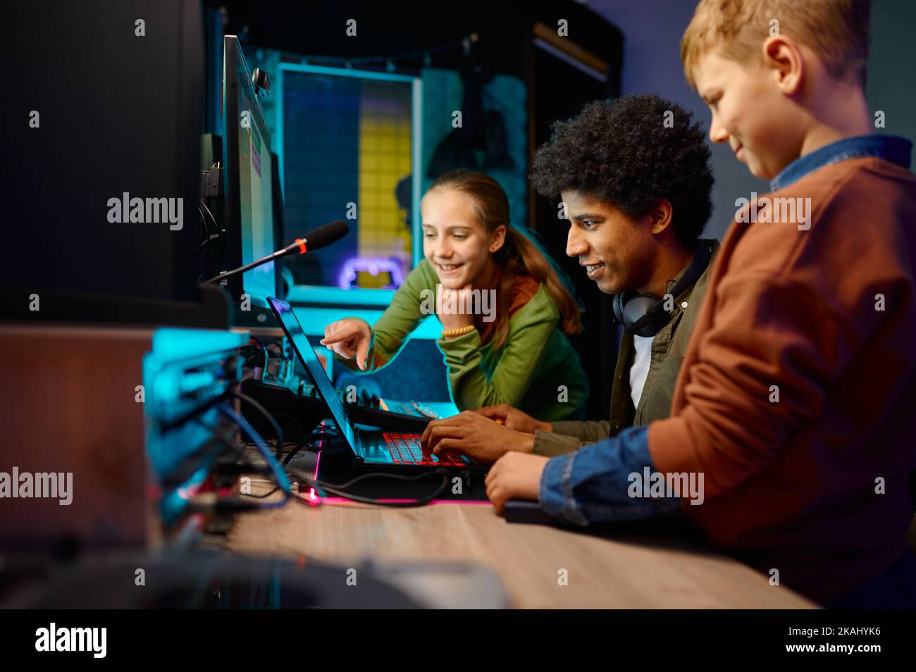 Sound producer mixing track with children band Stock Photo - Alamy