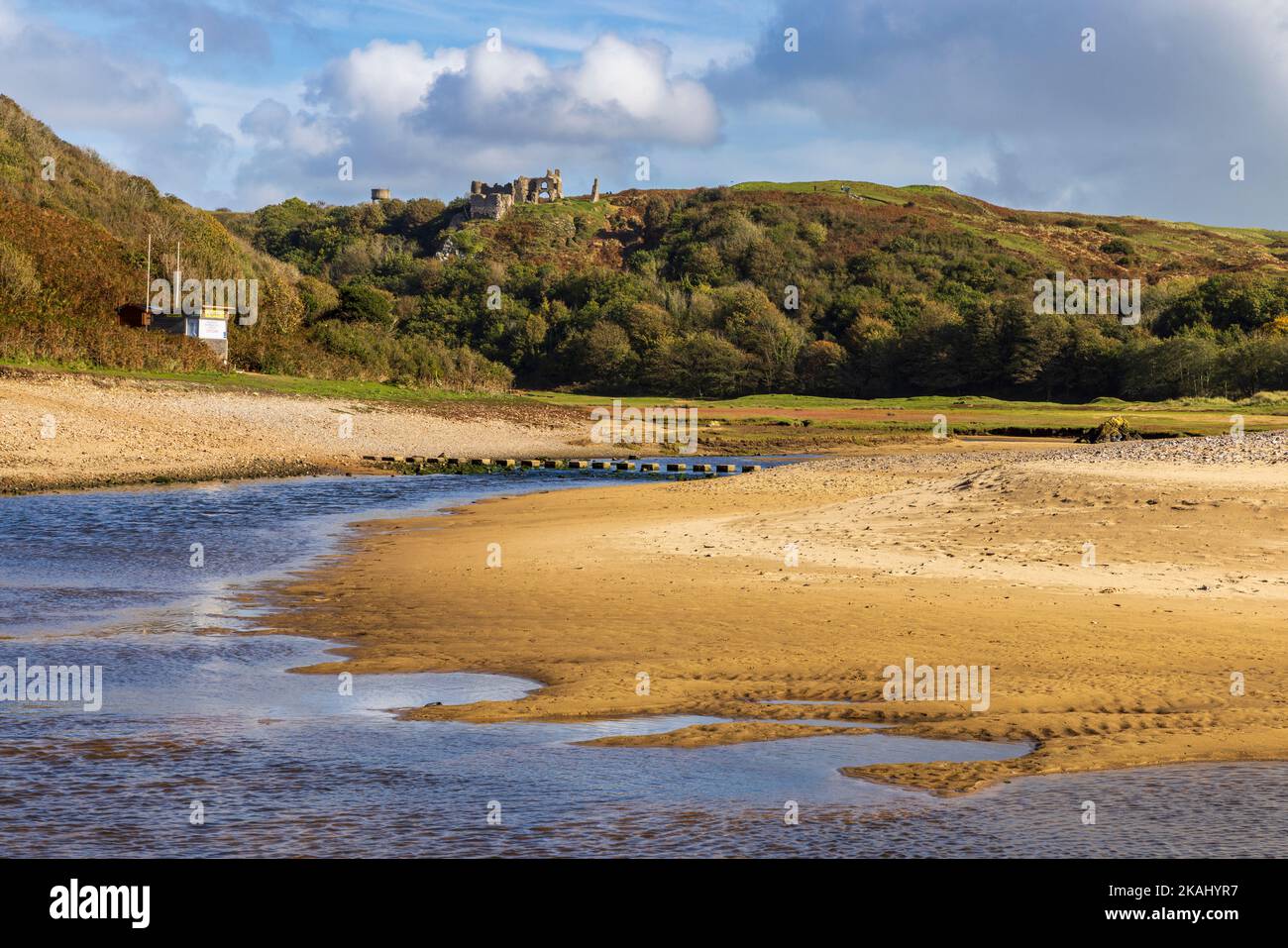 Pennard Pill flowing in to Three Cliffs Bay overlooked by Pennard ...
