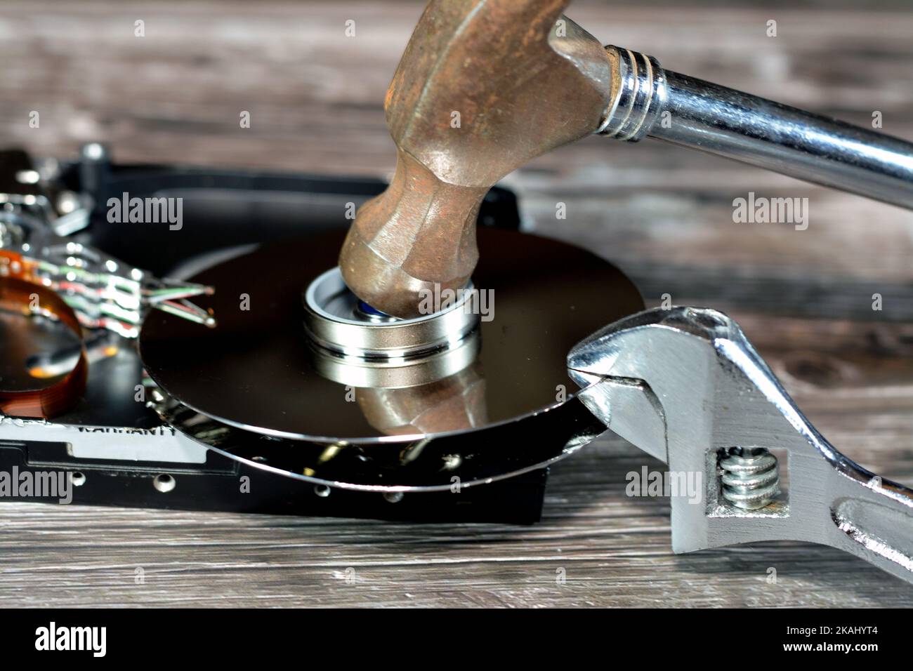 Spanner wrench and steel hammer with HDD platters, hard disk drive ...