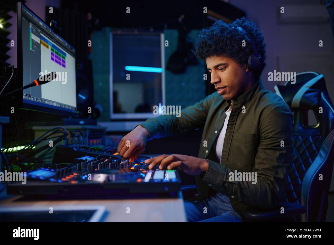 Portrait of radio host using sound mixer in studio Stock Photo - Alamy