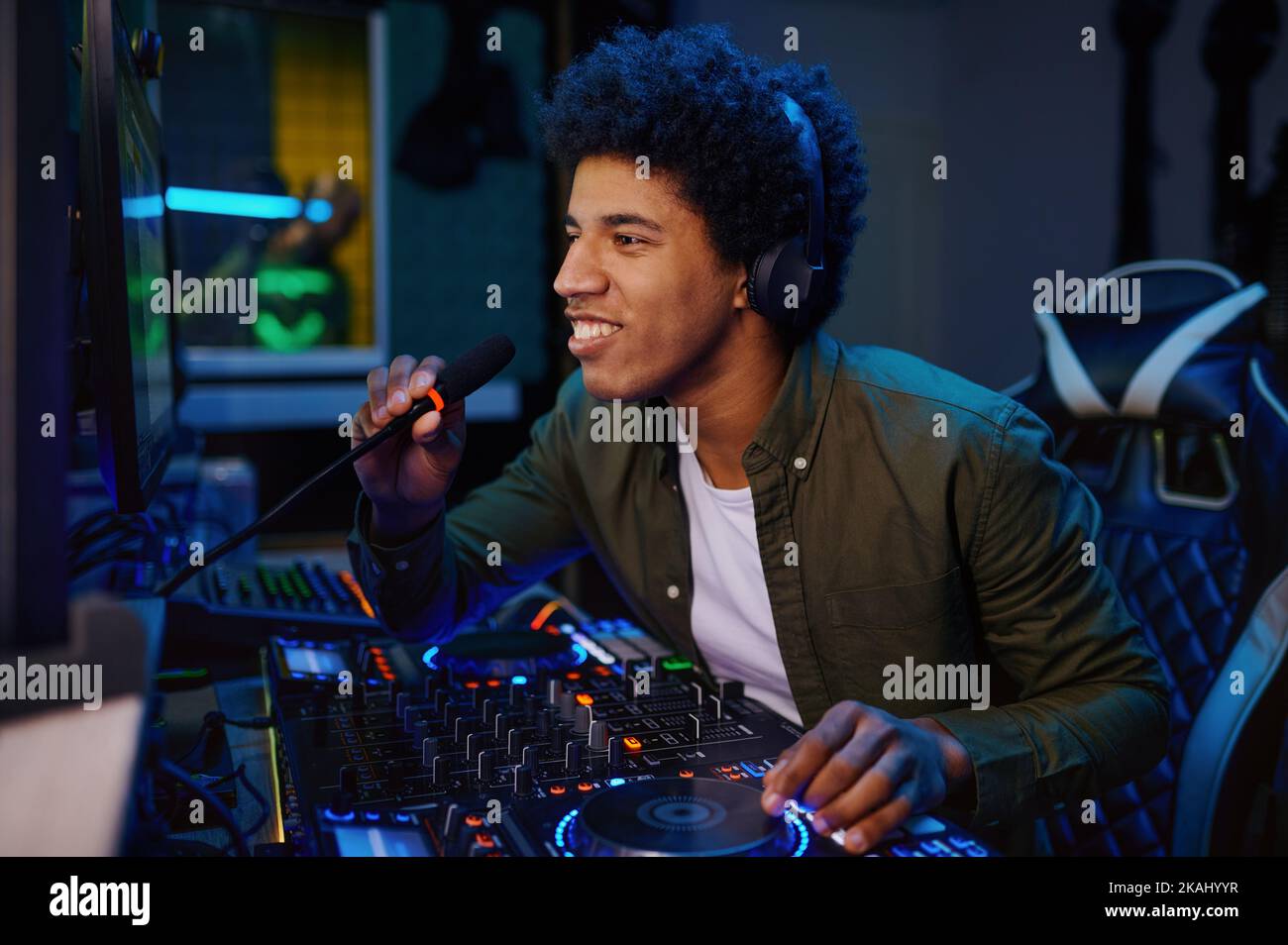 Radio host speaking into microphone Stock Photo - Alamy