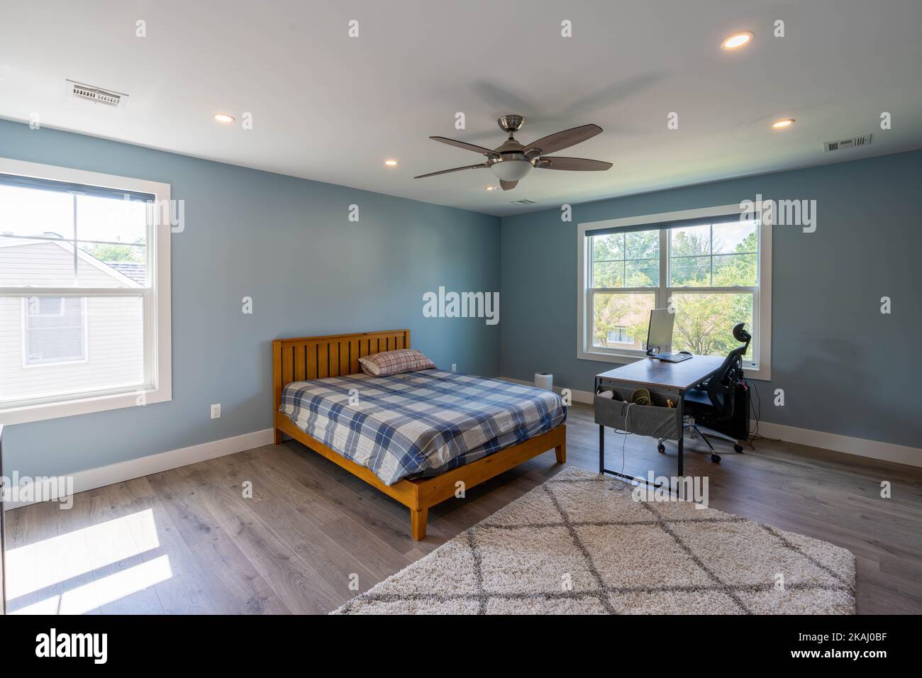 An interior of a modern renovated and furnished bedroom with two big ...