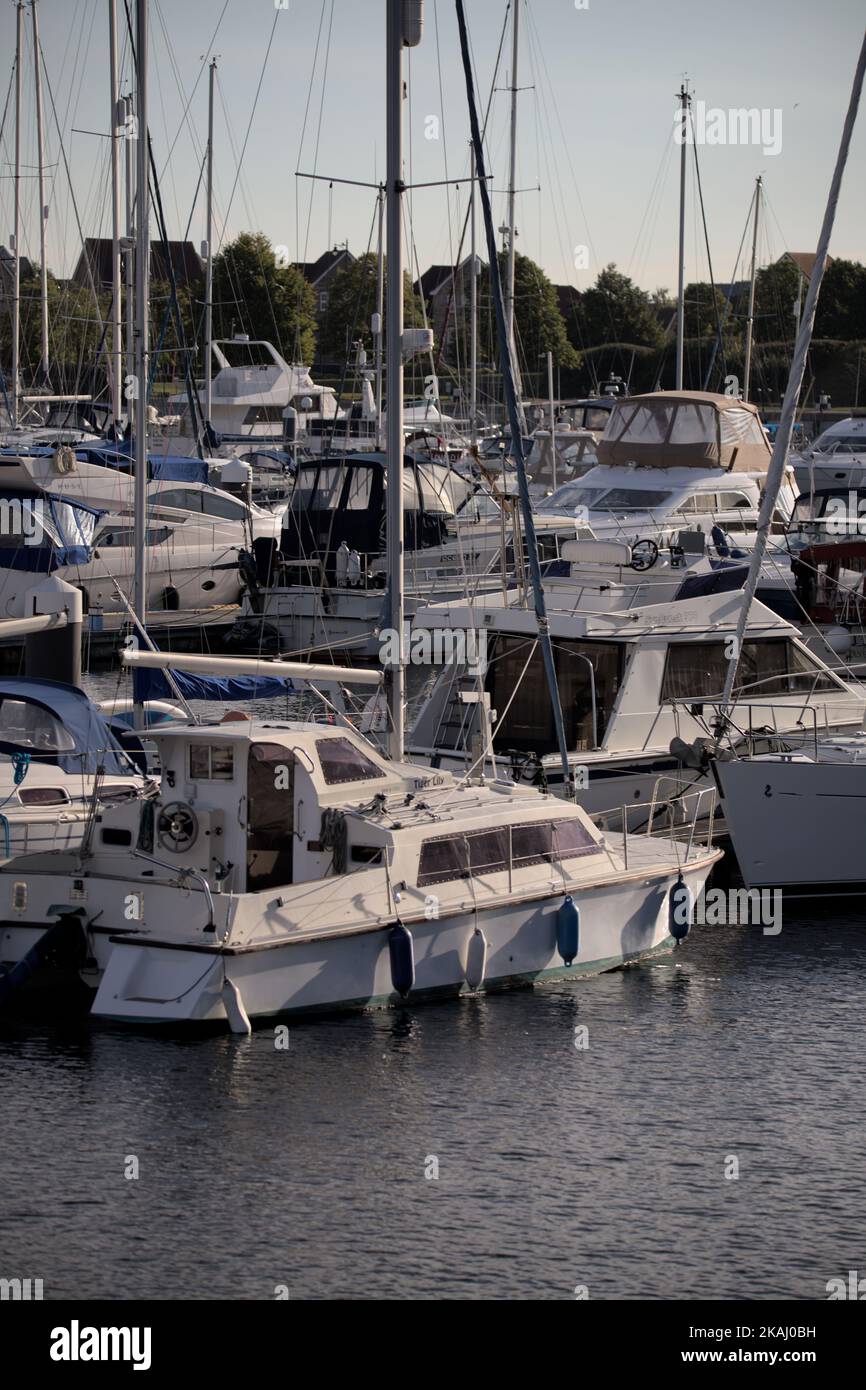 A vertical shot of row of empty docked boats at Chatham Harbor in the ...