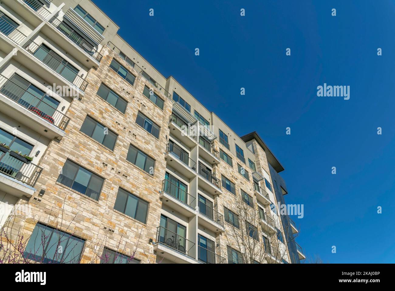 Modern luxury apartments with stone brick wall facade and small ...