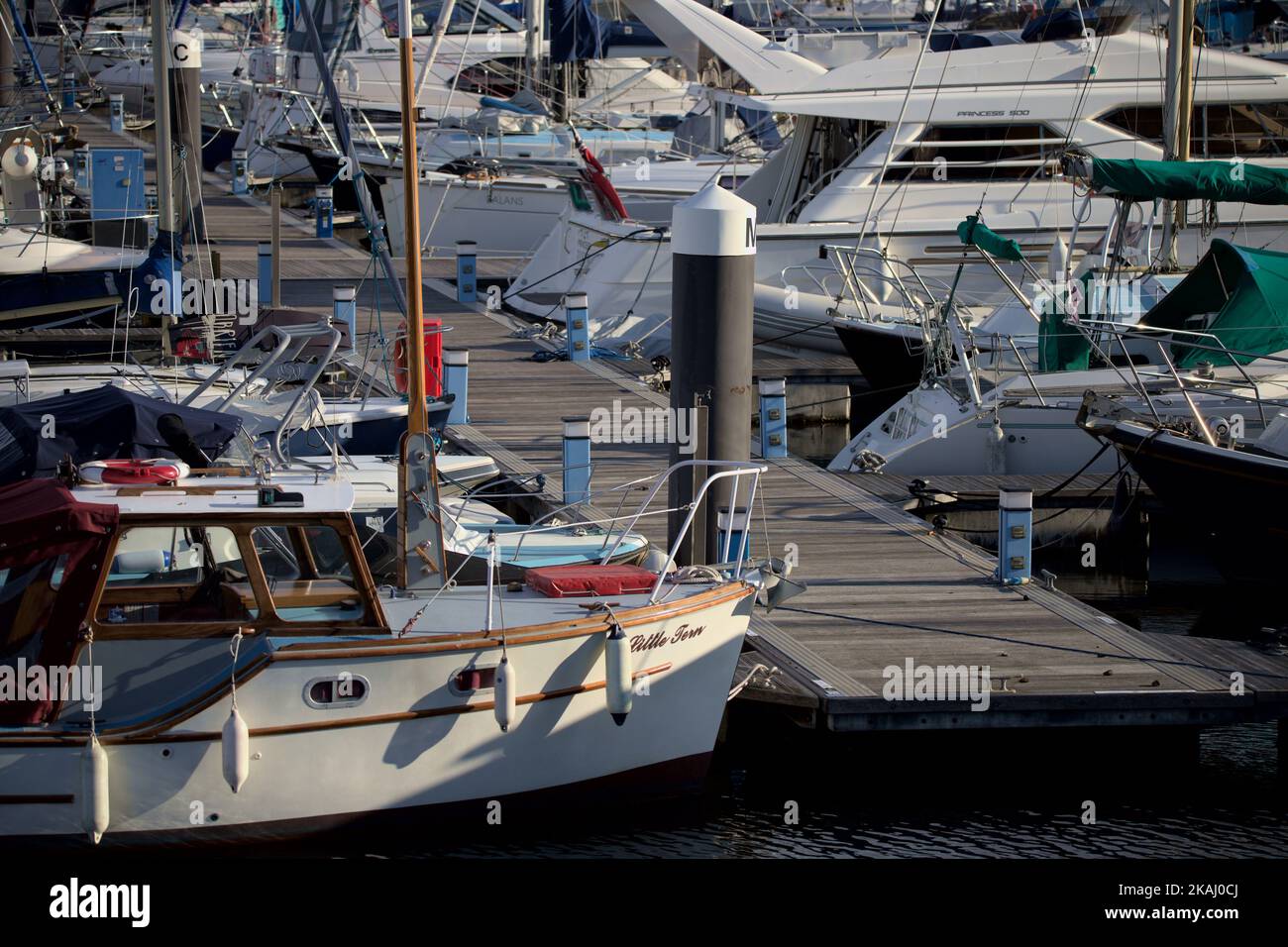 A row of empty docked boats at Chatham Harbor in the UK Stock Photo - Alamy