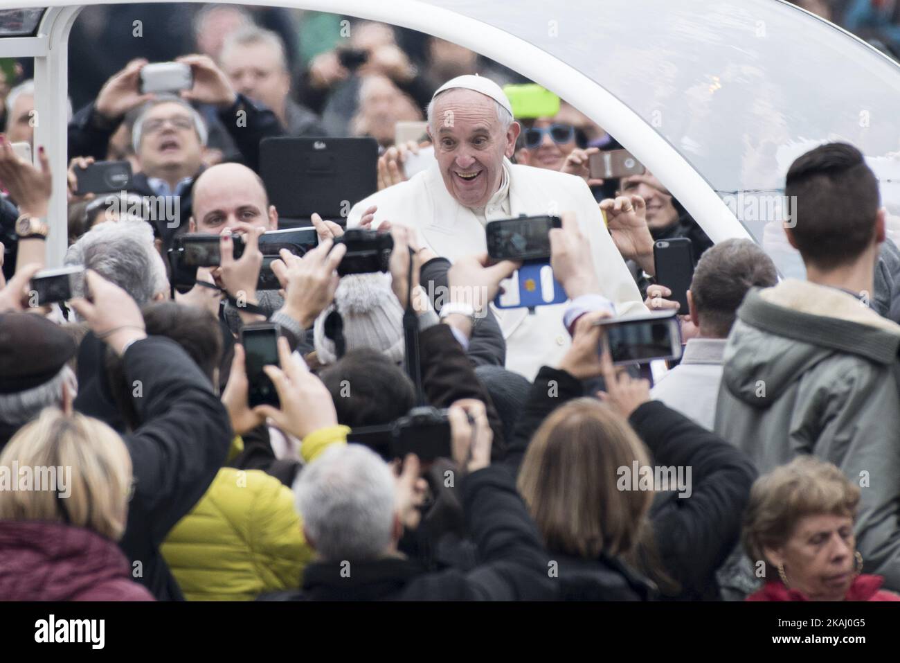 Pope Francis waves to faithful as he arrives for a special audience, at ...