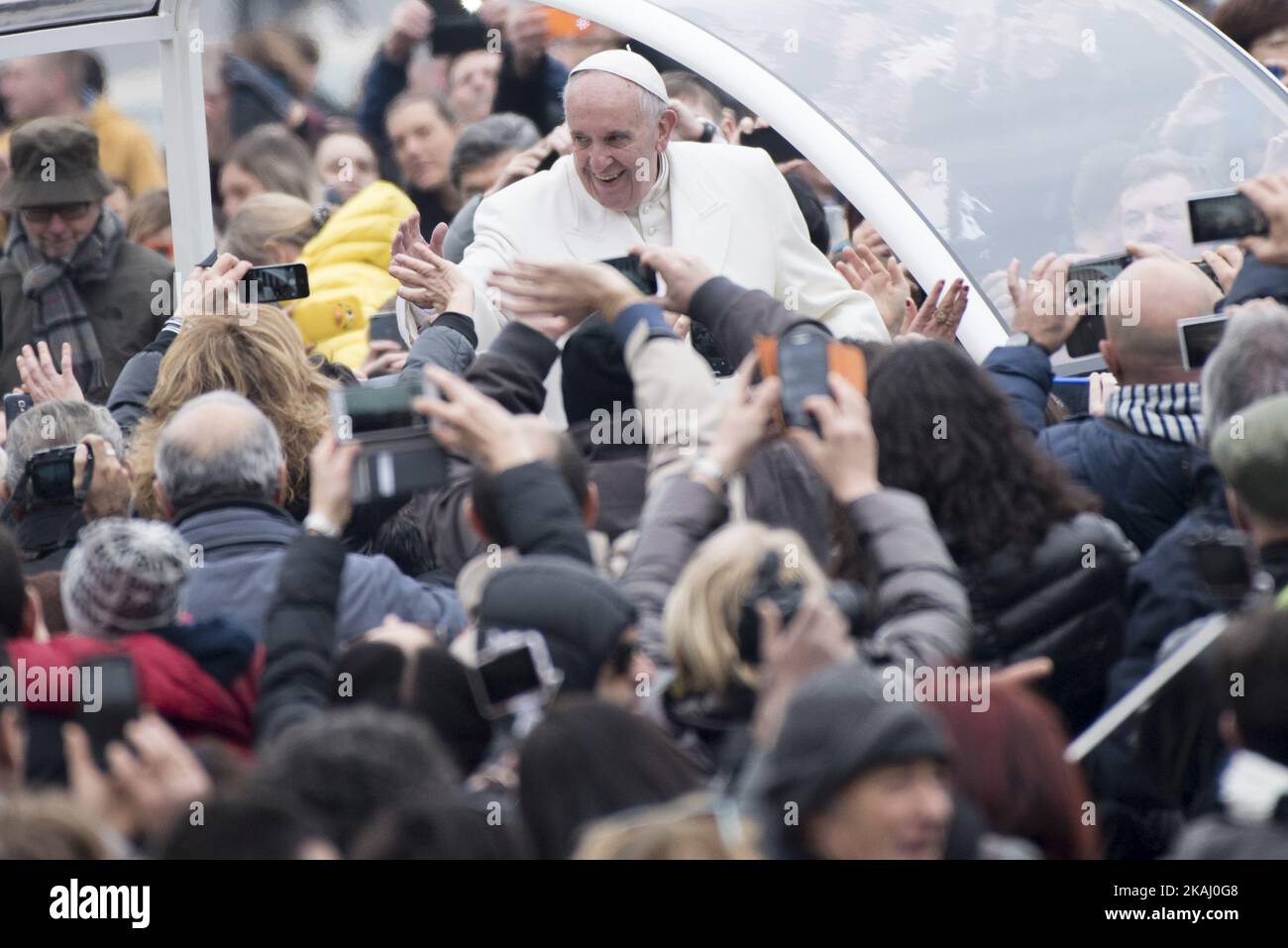 Pope Francis waves to faithful as he arrives for a special audience, at ...
