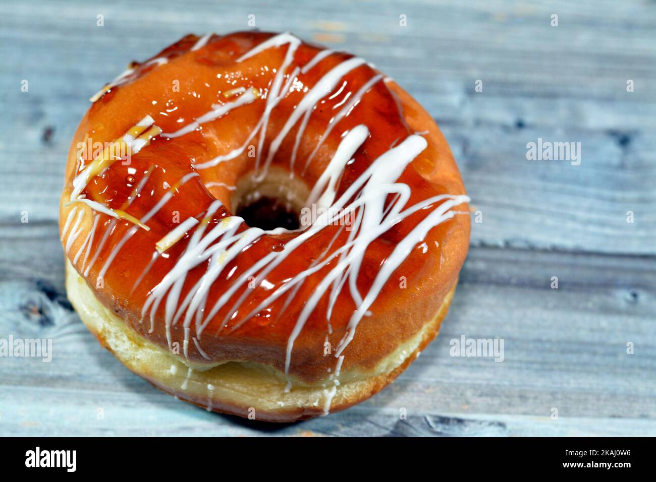 A ring donut with caramel and white chocolate sauce, A glazed, yeast ...